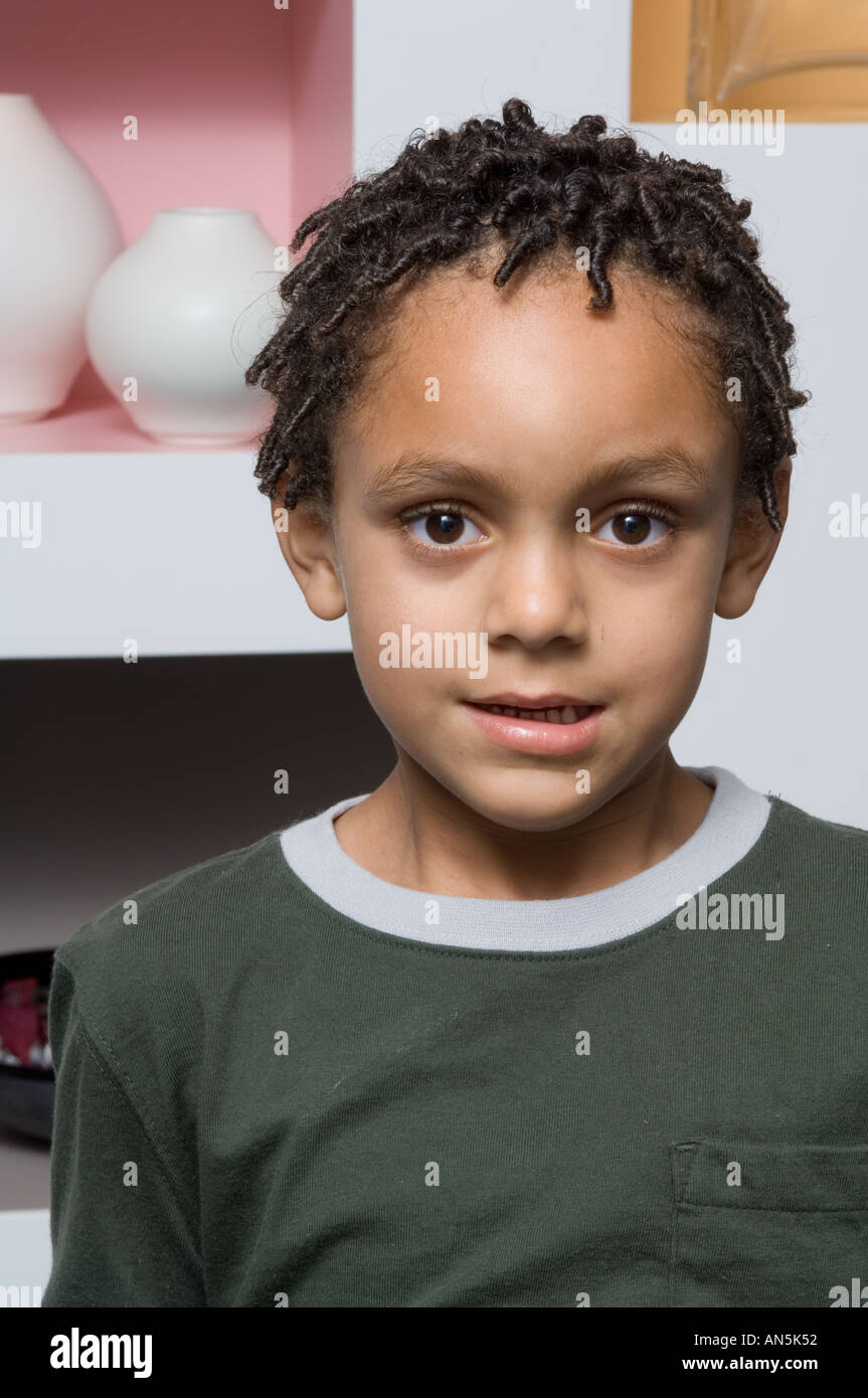Portrait of a young boy looking uncomfortable Stock Photo - Alamy