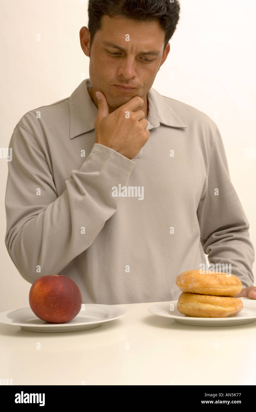 Portrait of male trying to choose what to eat Stock Photo - Alamy