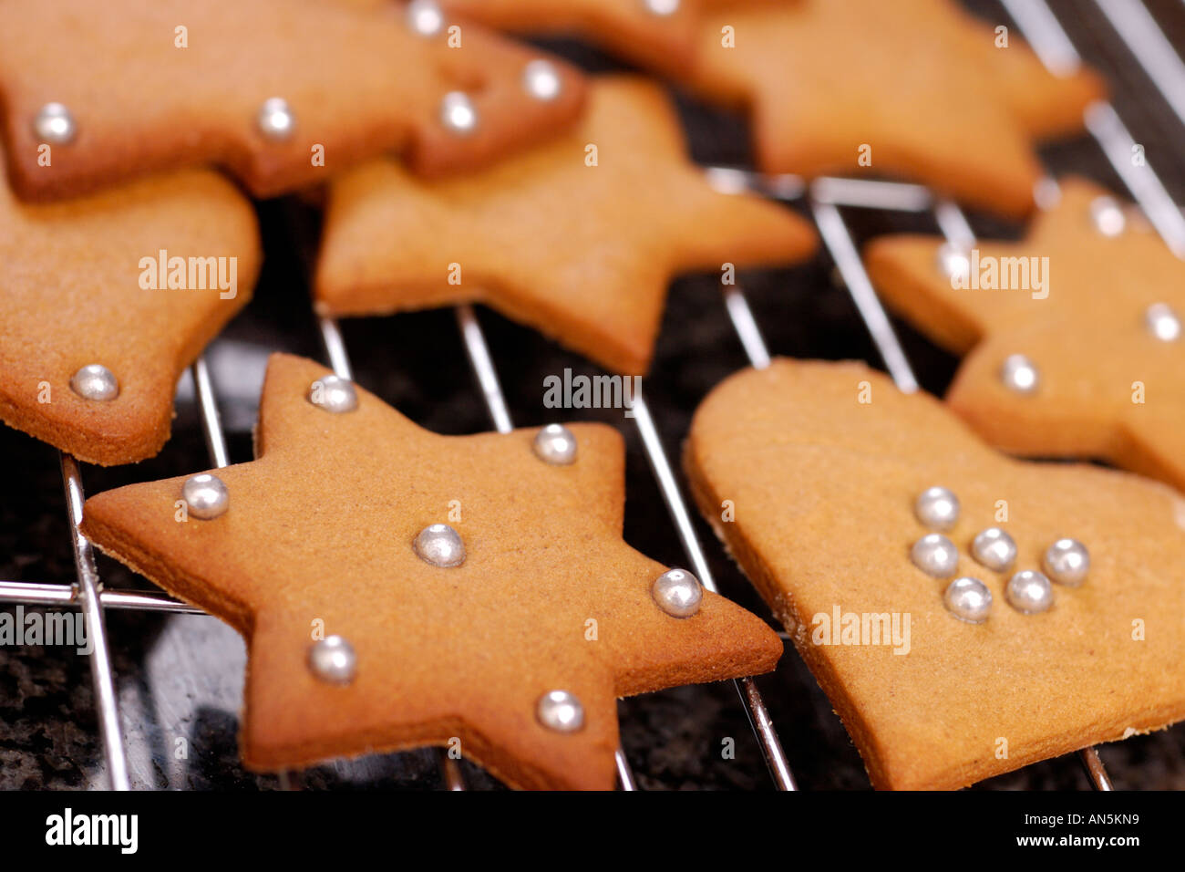 Christmas themed gingerbread biscuits cooling on wire rack Stock Photo ...