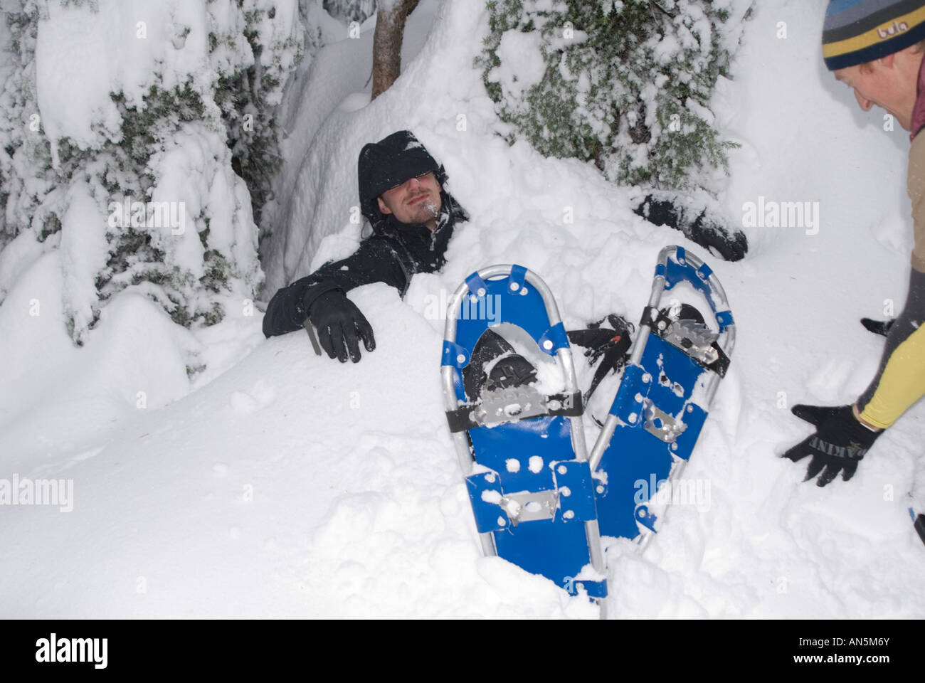 A helping hand for a snowshoer who has fallen down Stock Photo - Alamy