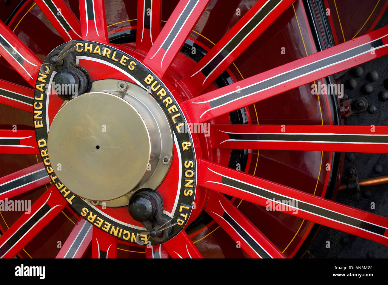Close up detail of red iron wheel of vintage steam traction engine at a ...