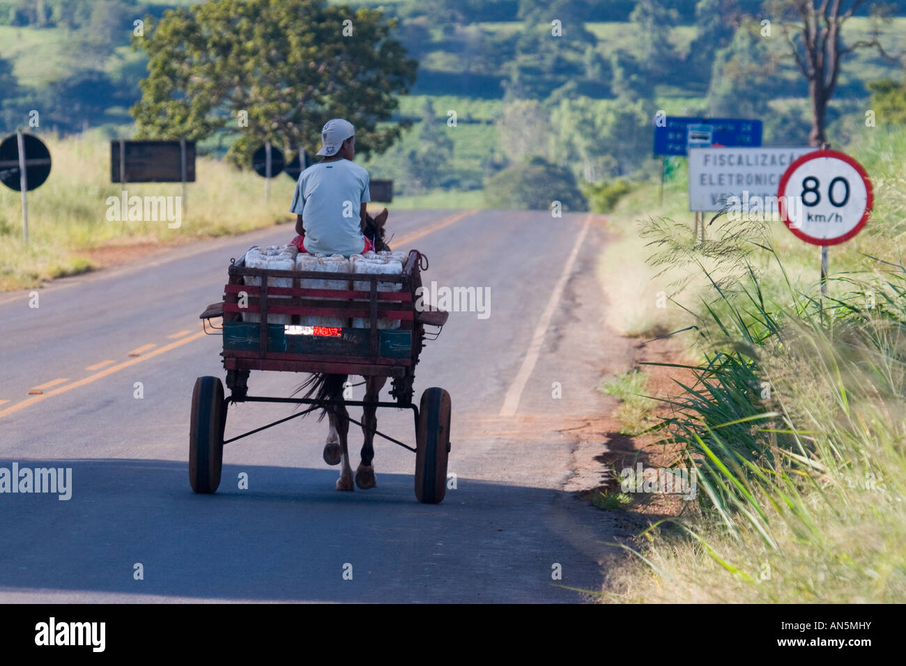 Picture of a boy riding a cart. A speed limit sign can be seen on the ...
