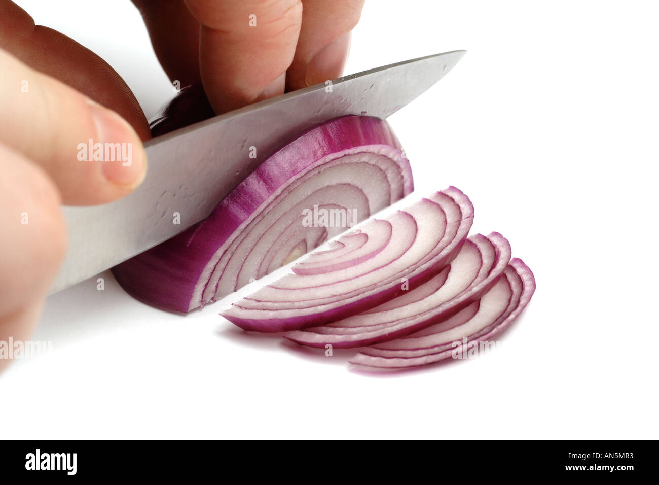 Man slicing red onion on white background Stock Photo - Alamy