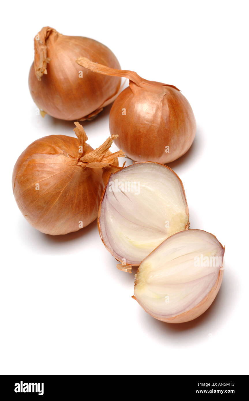 Shallots one halved on white background Stock Photo - Alamy