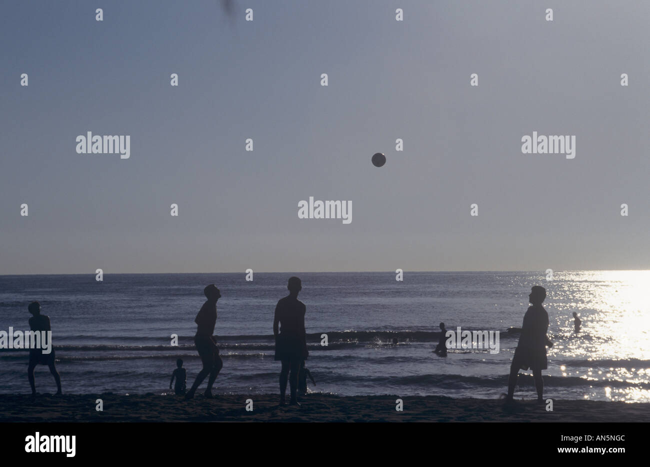People playing ball game on beach Stock Photo - Alamy