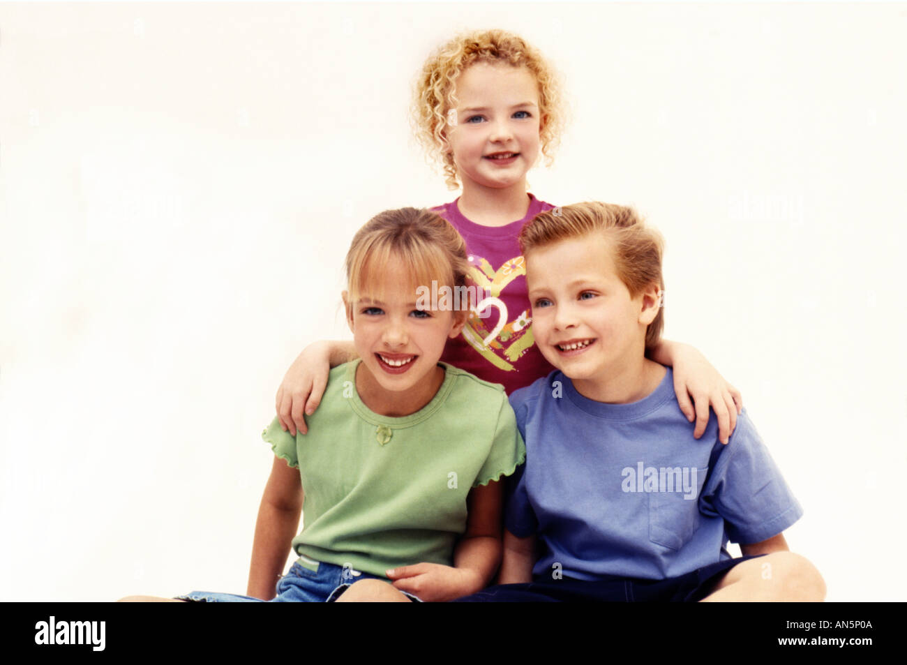 Three young children smiling Stock Photo - Alamy