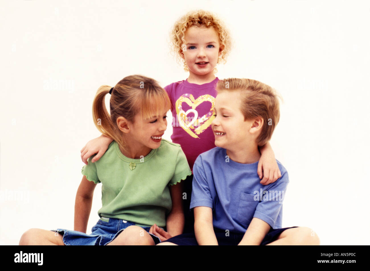 Three young children smiling Stock Photo - Alamy