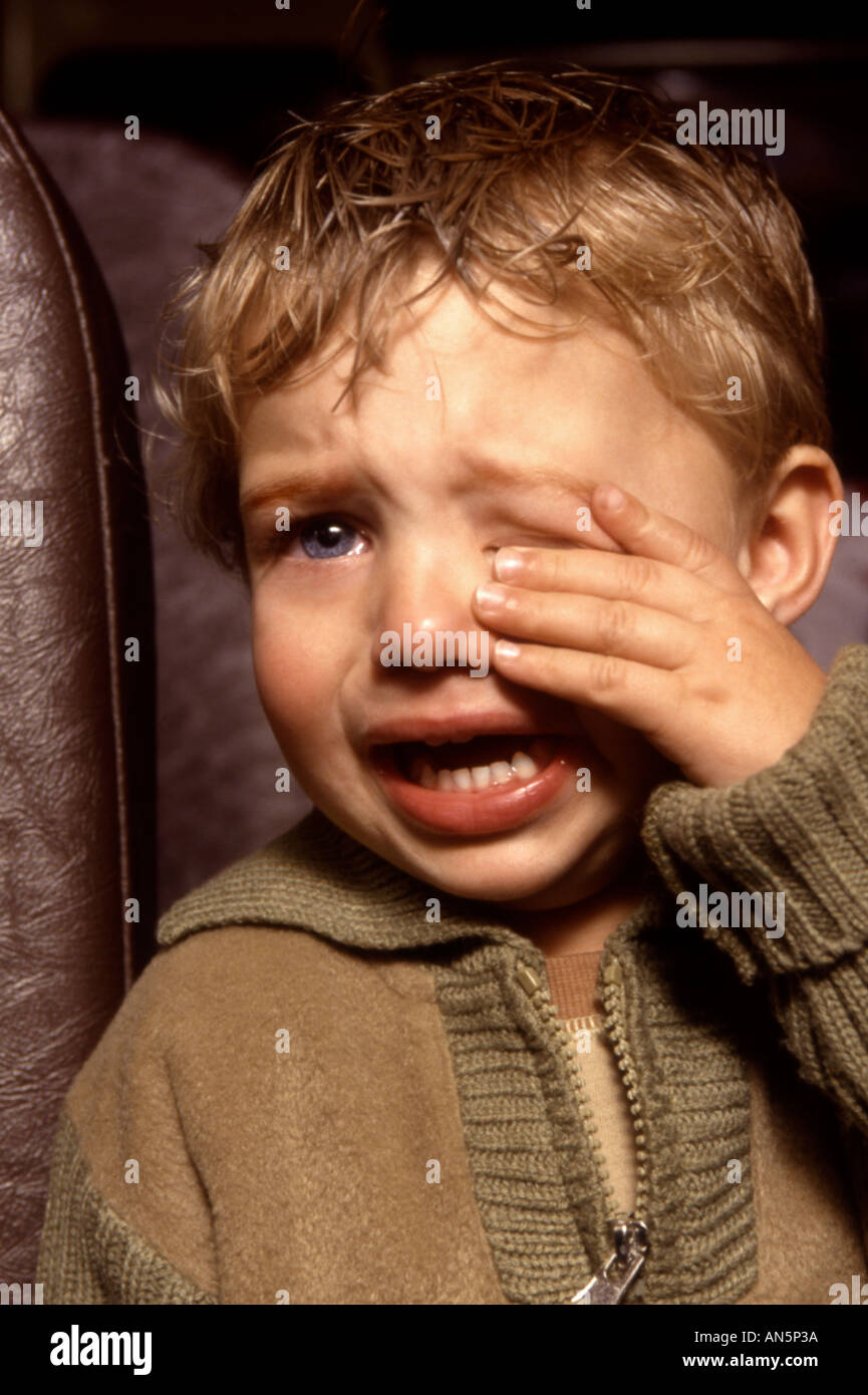 A young boy crying on a school bus Stock Photo - Alamy