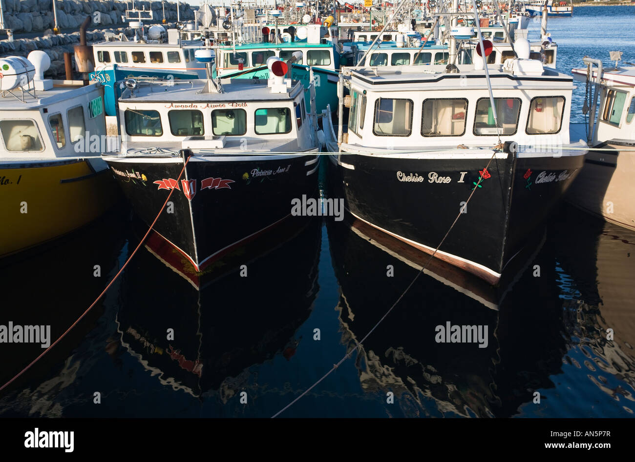 Lobster boats wait for the start of the season on a calm late afternoon ...