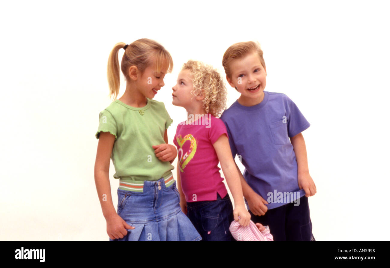 Three young children smile and laugh together Stock Photo - Alamy