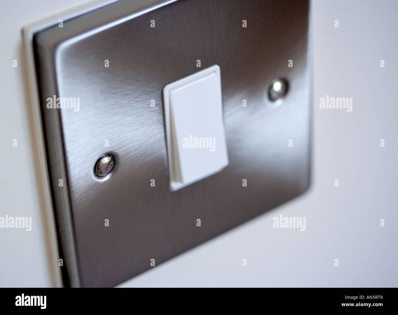 Silver metal UK light switch Stock Photo - Alamy