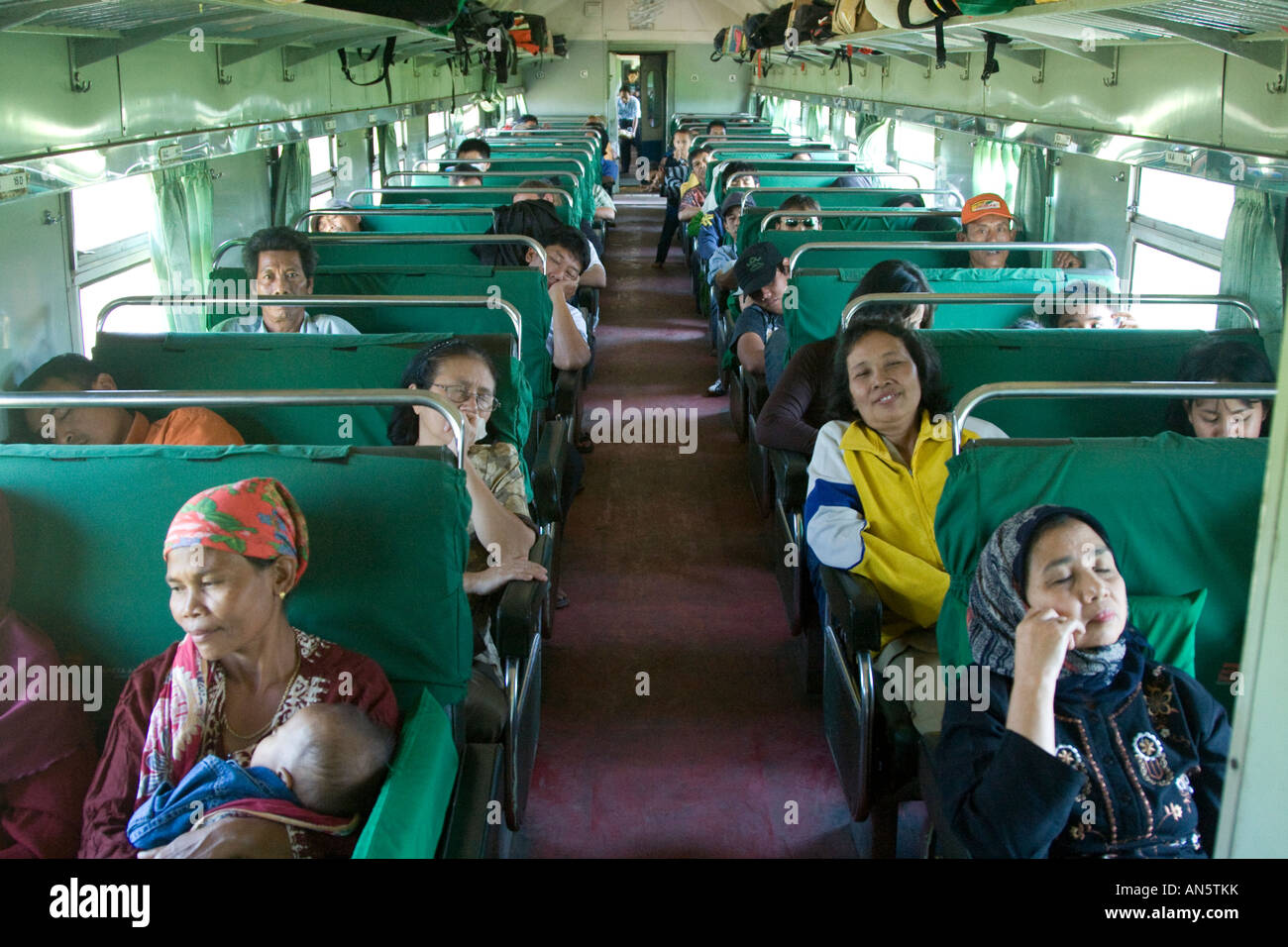 Riders Inside Indonesian Train in Java Indonesia Stock Photo - Alamy