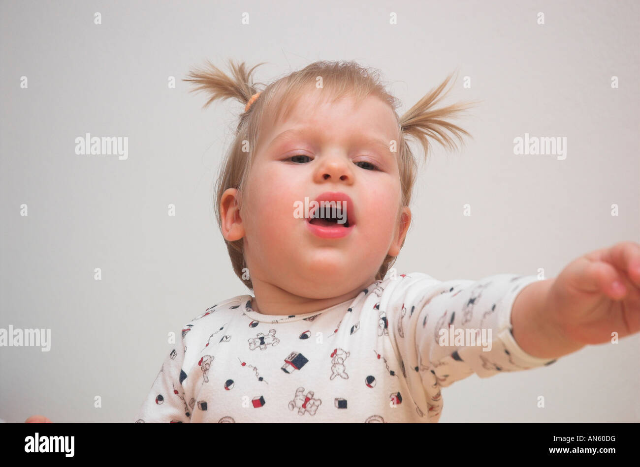 Baby girl reaching out Stock Photo - Alamy