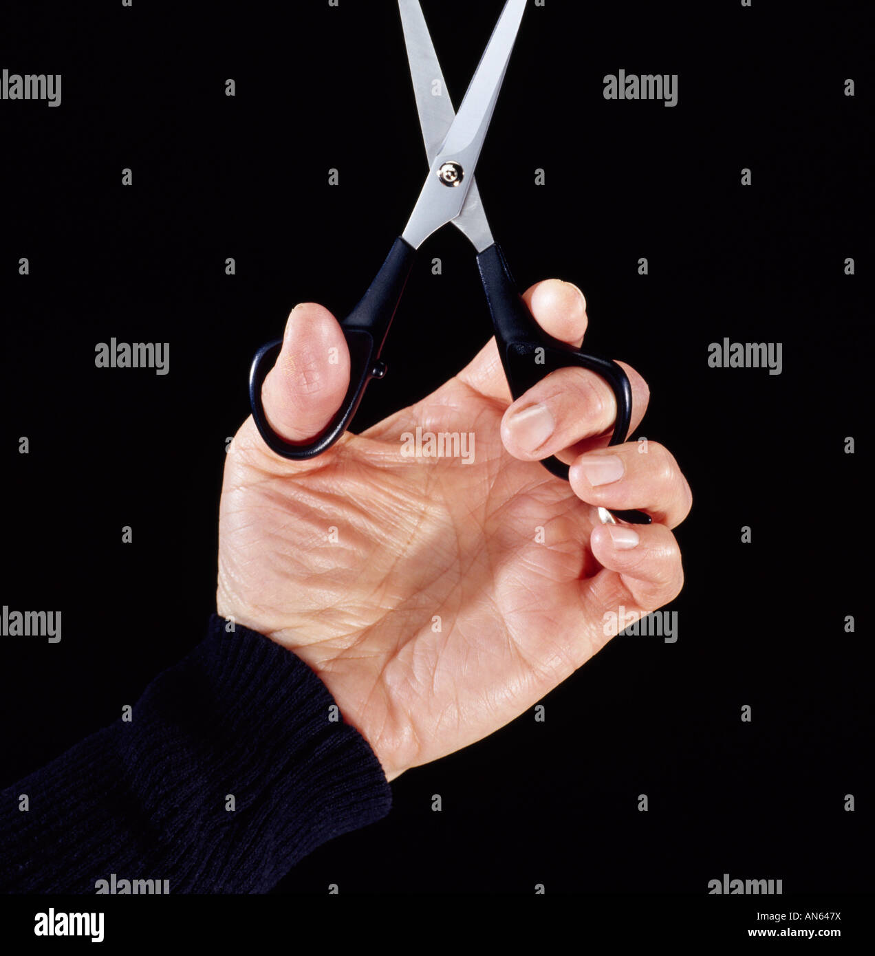 A hand holding scissors Stock Photo - Alamy