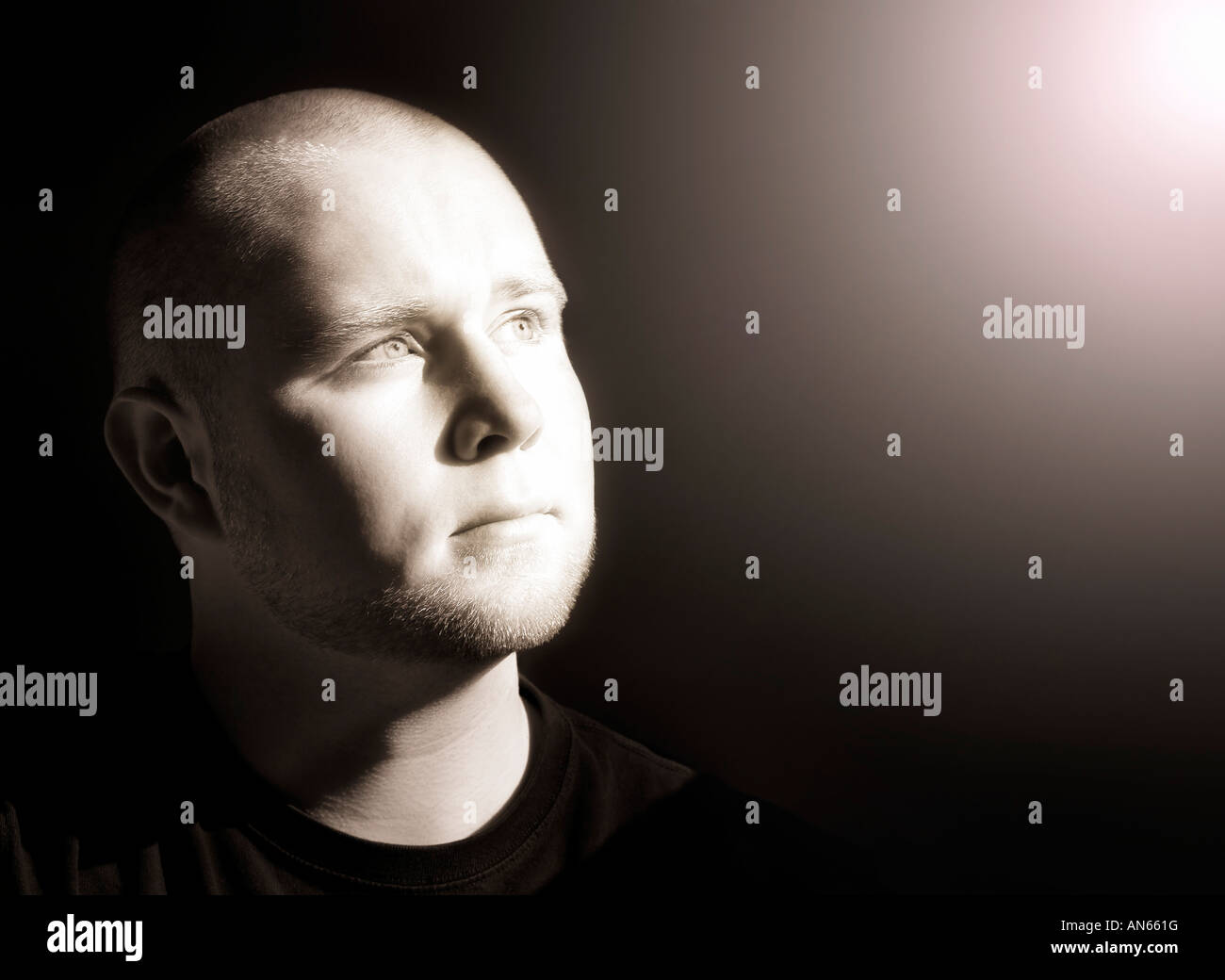 Portrait of man looking towards a light Stock Photo - Alamy