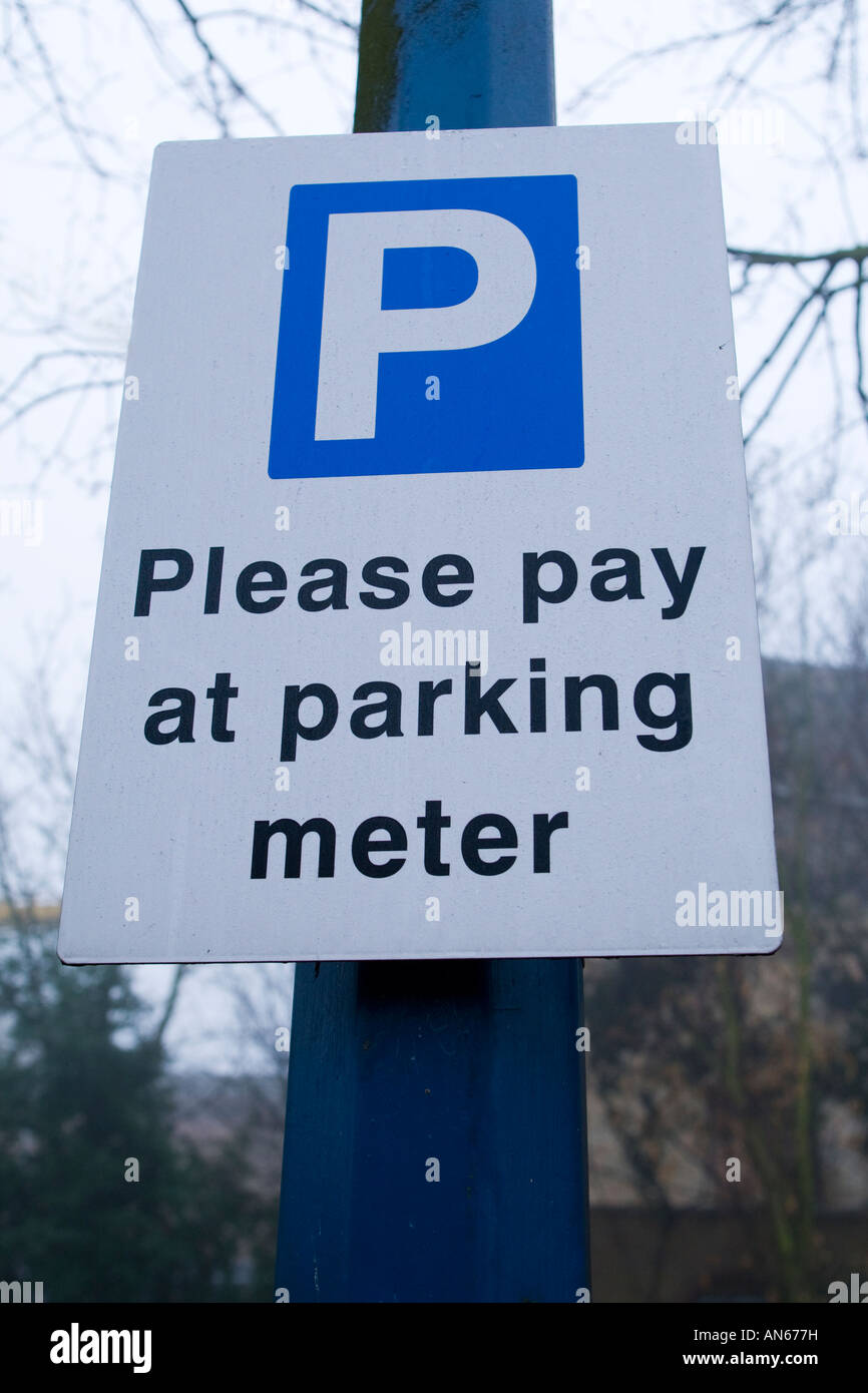 Sign pay at parking meter Stock Photo - Alamy