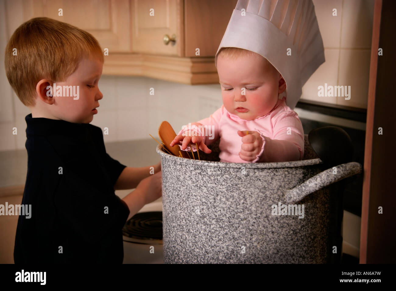 Children playing in the kitchen Stock Photo - Alamy