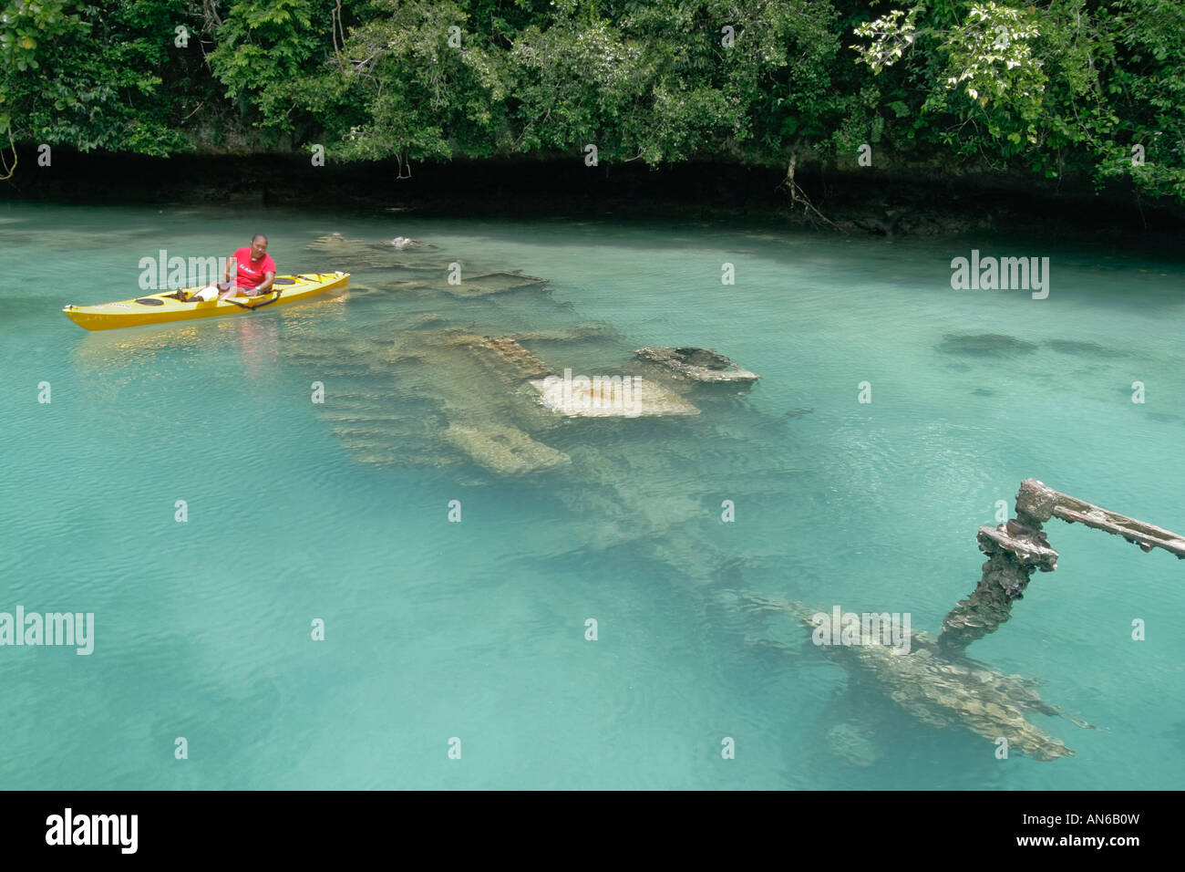 Kayker inspects sunken Japanese patrol boat in Shipwreck Bay Stock ...