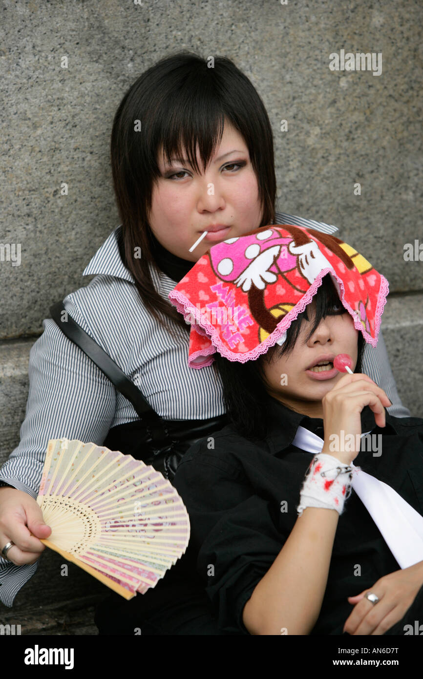 Teenage girls dressed in alternative street fashion relax in Harajuku ...
