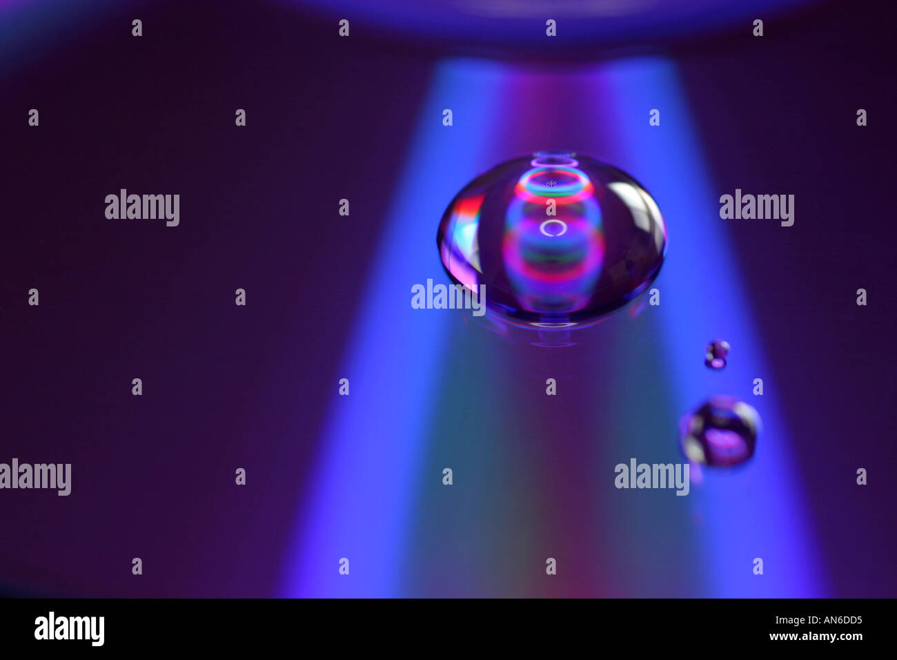 Reflections in a single water droplet on a blue CD R compact disc CD ...