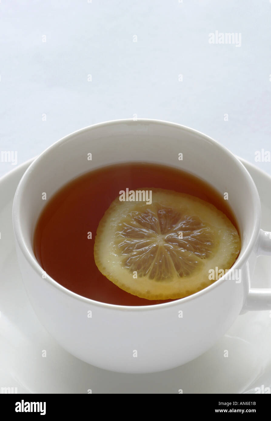 Hot lemon tea in a white cup and saucer Stock Photo - Alamy