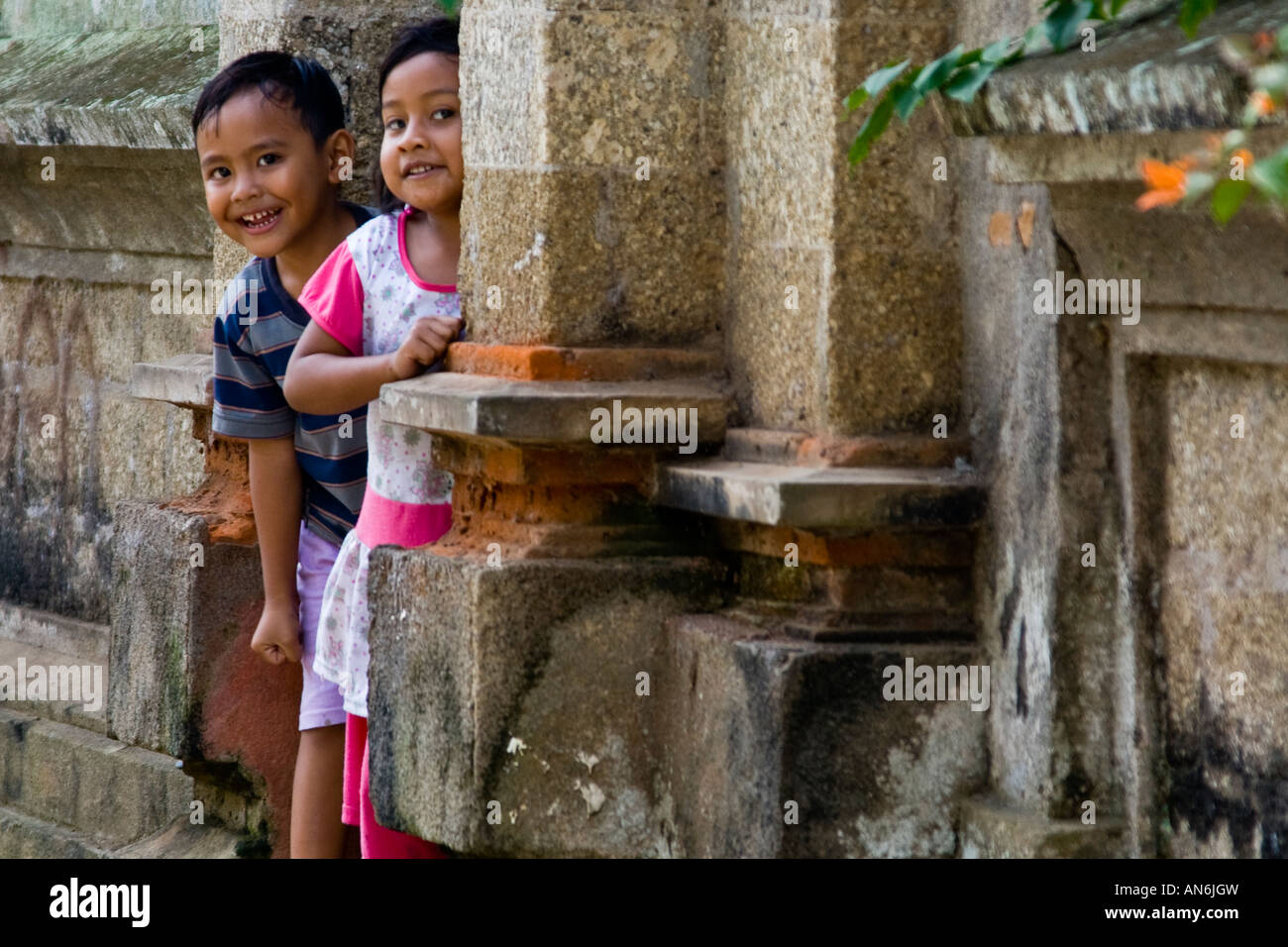 Balinese Children Peeking from behind a Corner Ubud Bali Indonesia ...
