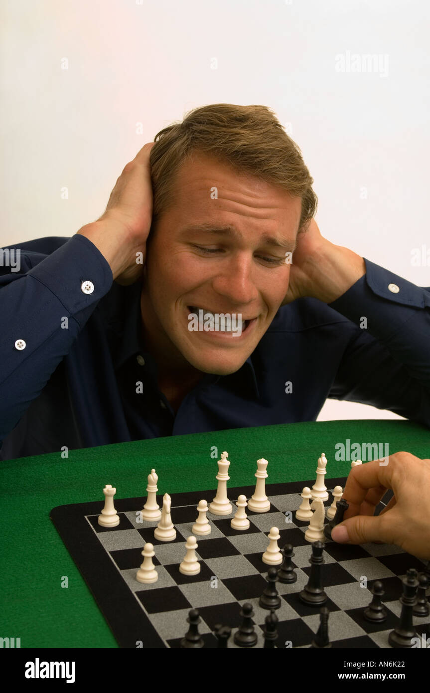 Portrait of a man loosing a game of chess Stock Photo - Alamy