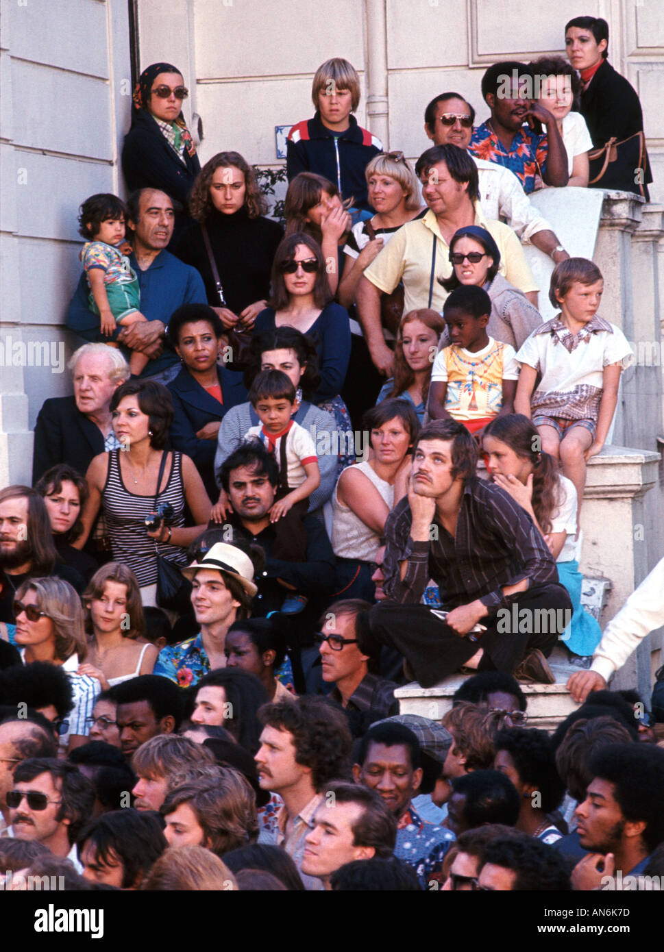 Crowd of people sitting on steps Stock Photo - Alamy