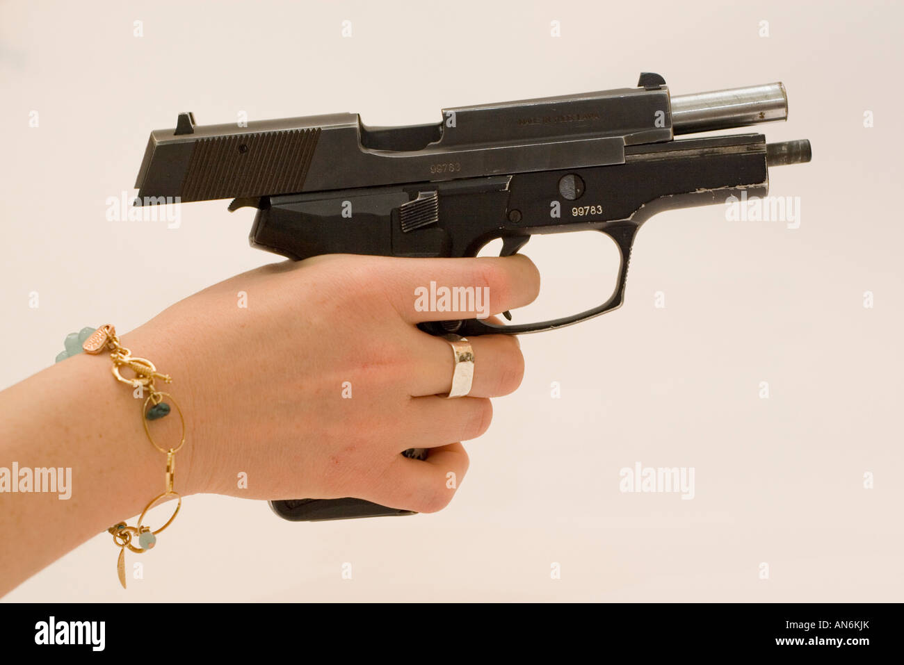 side view of a woman holding and aiming a Czech CZ 99 9mm parabelum ...