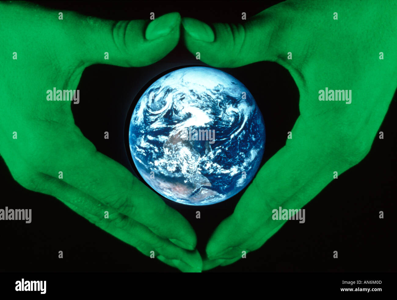 Green hands holding planet Earth Stock Photo - Alamy