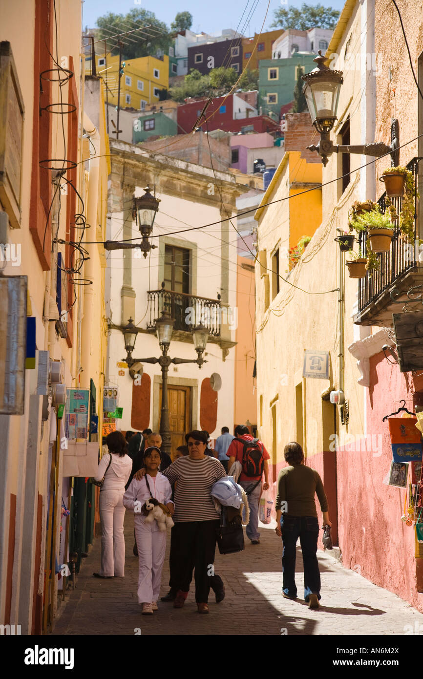 MEXICO Guanajuato People walk in narrow alley between buildings ...
