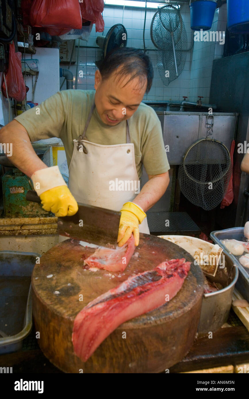 Man filleting fish in the fish market in Kowloon Hong Kong Stock Photo ...