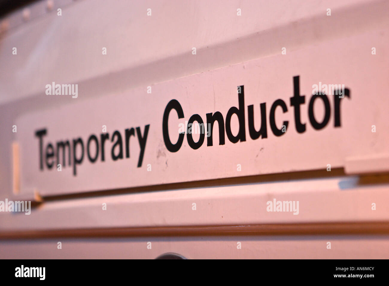 Sign on bus saying temporary conductor Stock Photo - Alamy