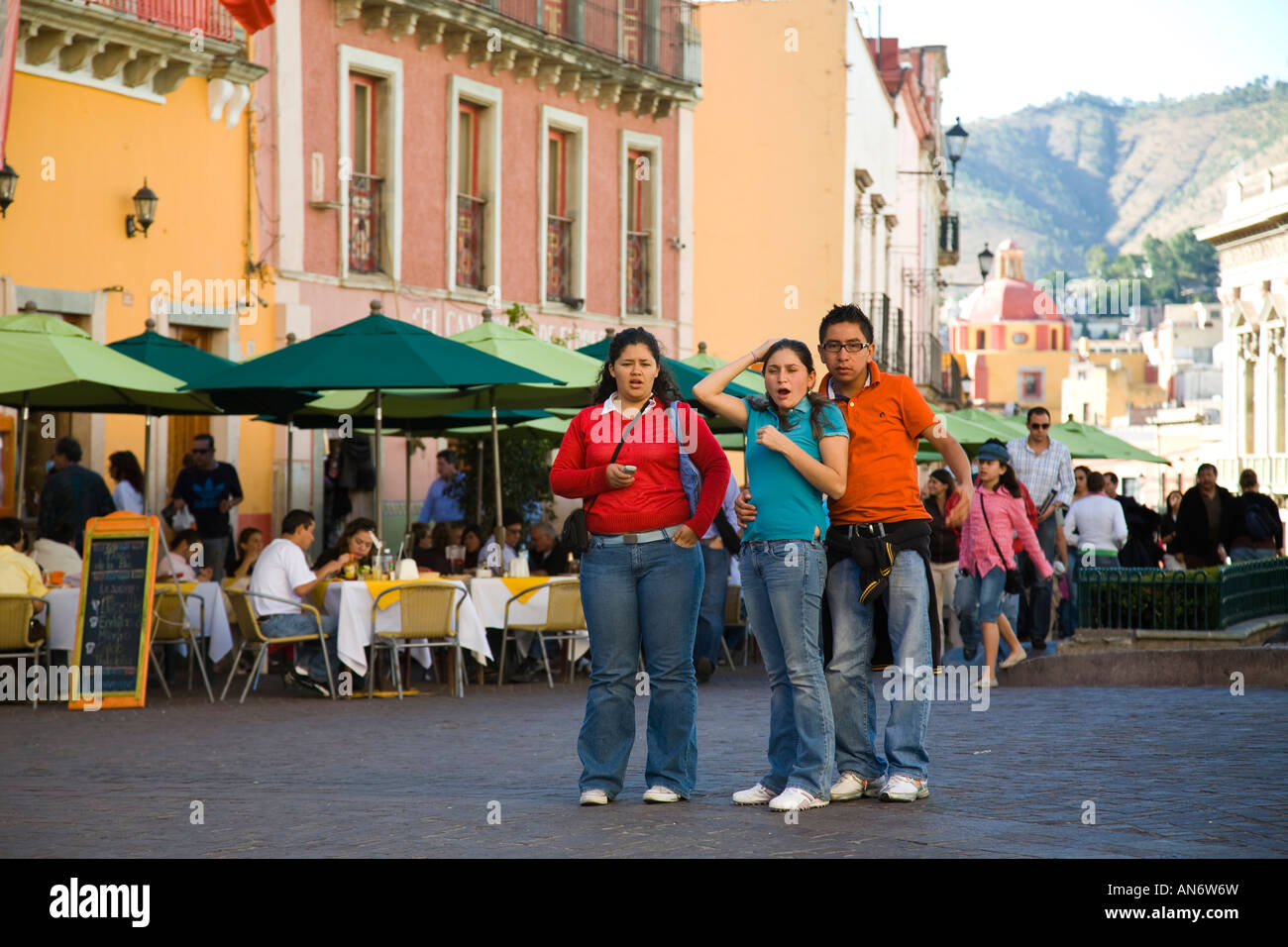 MEXICO Guanajuato Three teens in Plaza de la Paz people dining outside ...