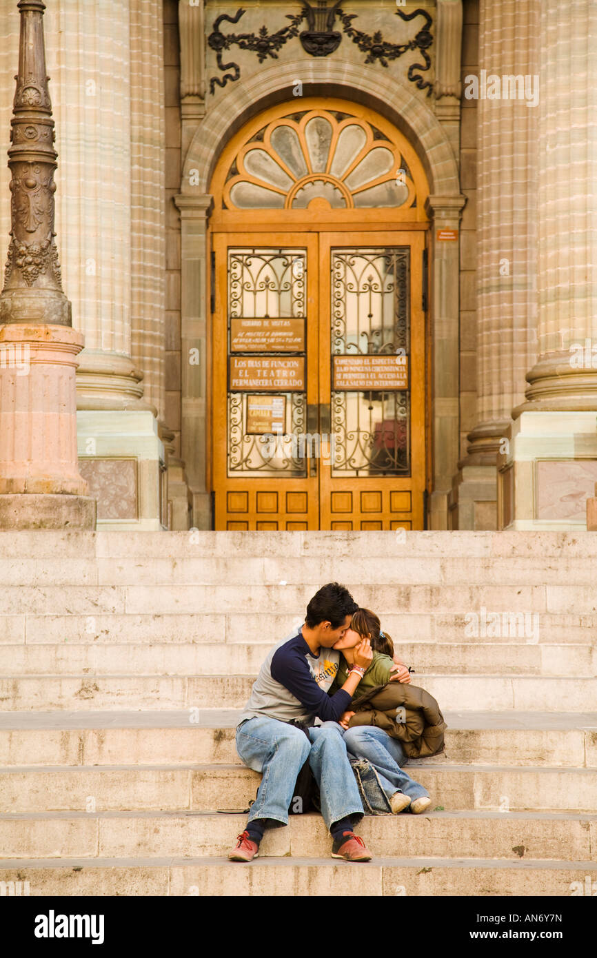 MEXICO Guanajuato Young adult couple kissing on steps of Teatro Juarez ...