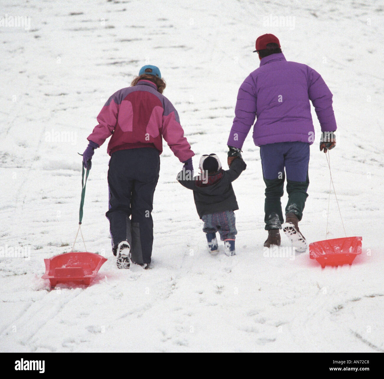 Mother Father and child sledging in Scotland Stock Photo - Alamy