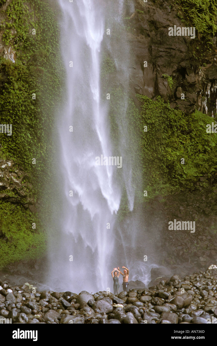Divers cool off under a waterfall Stock Photo - Alamy