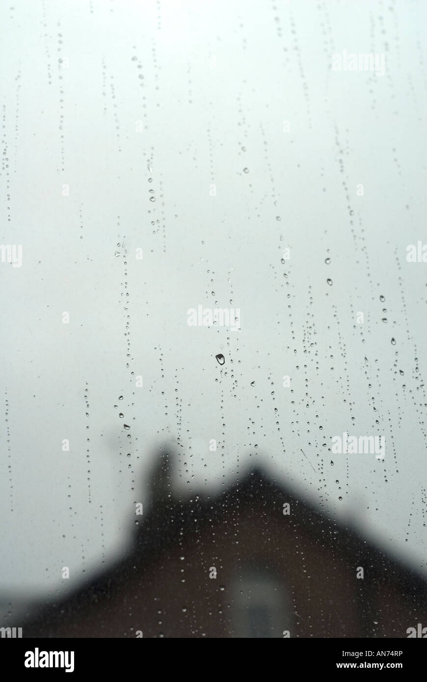 Rain drops on house window view from inside Stock Photo - Alamy