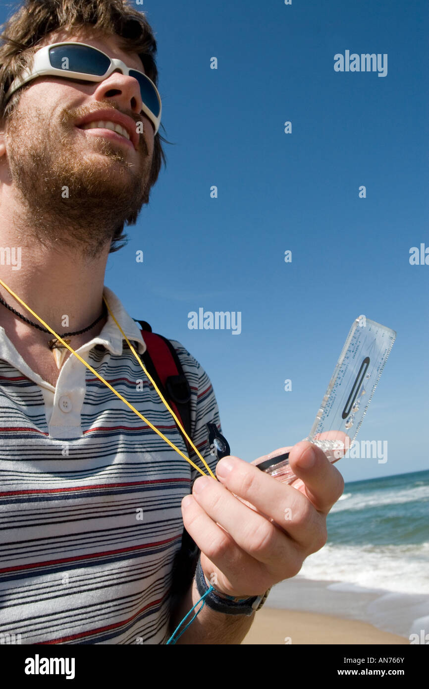 Man with Compass on Beach Stock Photo - Alamy