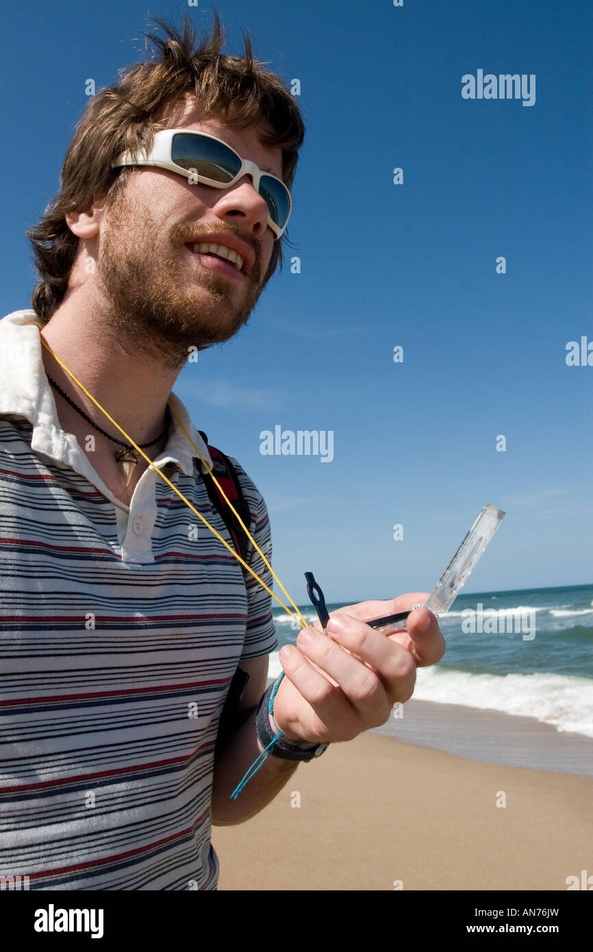 Man with Compass on Beach Stock Photo - Alamy