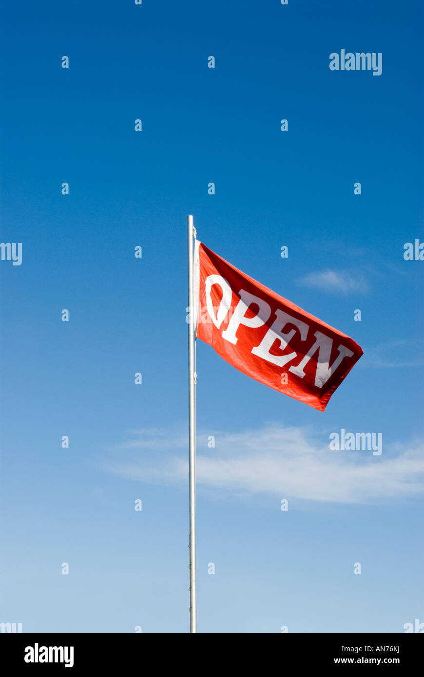 Red Open flag against blue sky Stock Photo - Alamy