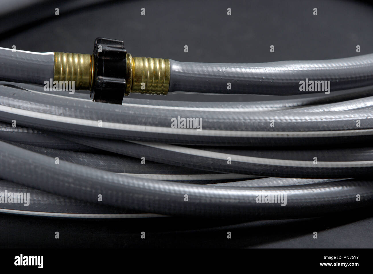 A garden hose coiled in storage Stock Photo - Alamy