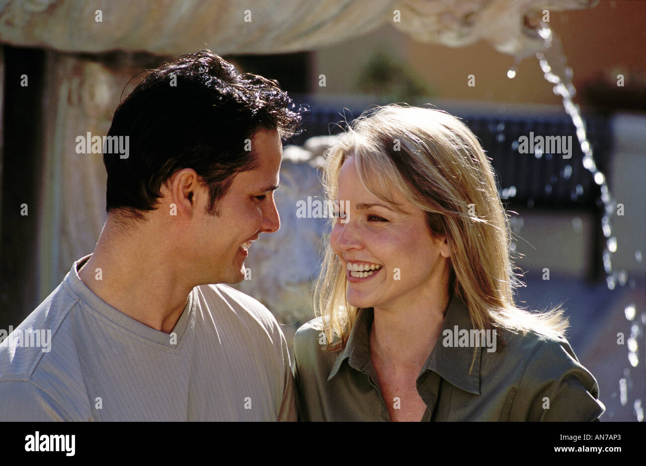 A Romantic Couple Shares a laugh in front of a Fountain Stock Photo - Alamy