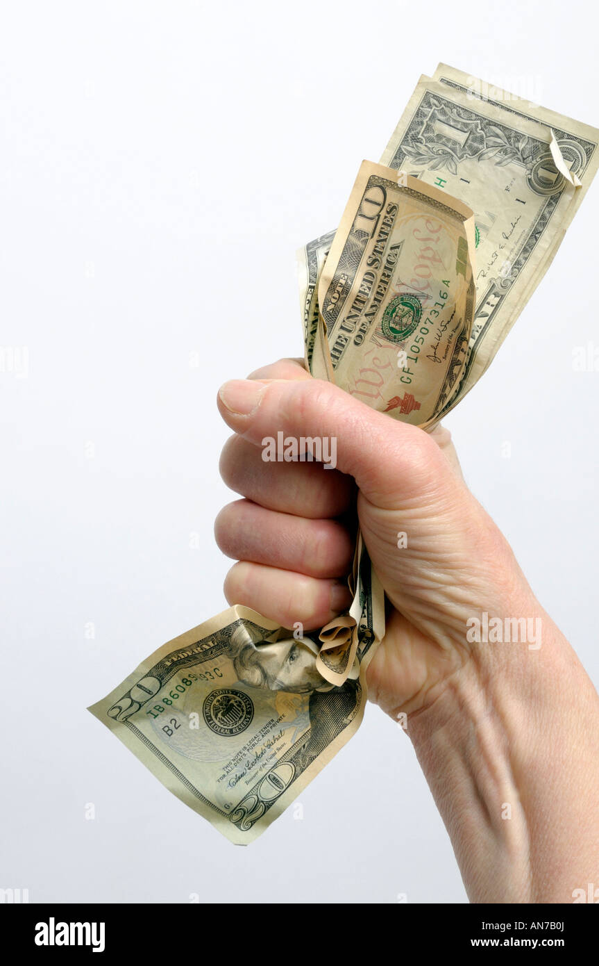 Hand squeezing money hi-res stock photography and images - Alamy