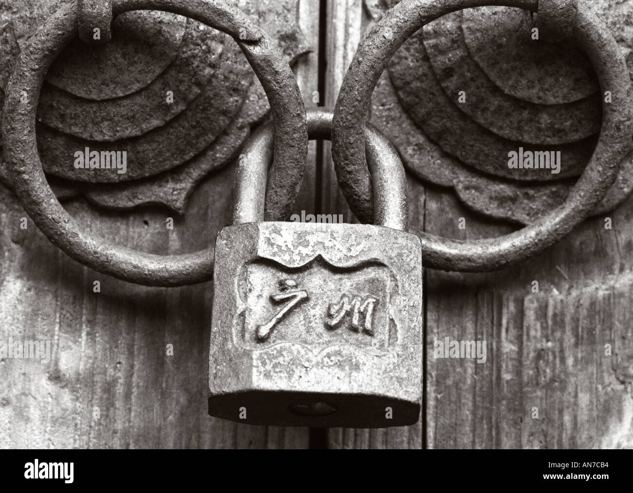 An old lock holds ancient door handles at Changlong. Guangdong Province ...