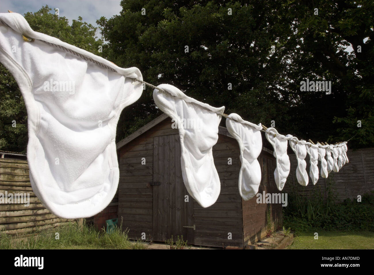 Terry nappies drying pegged out on the washing line Stock Photo - Alamy