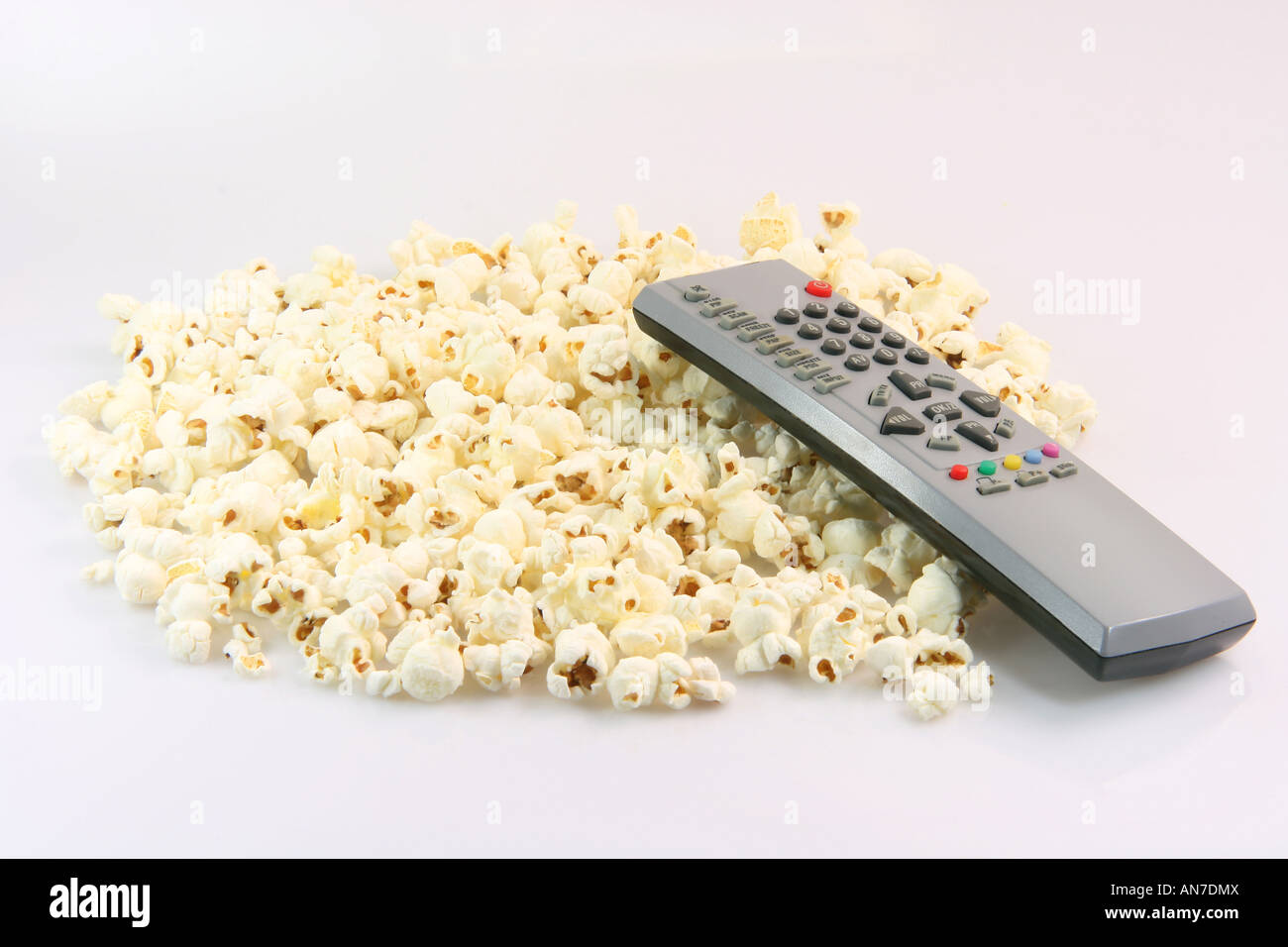 television remote control over pop corn food and entertainment conceps ...