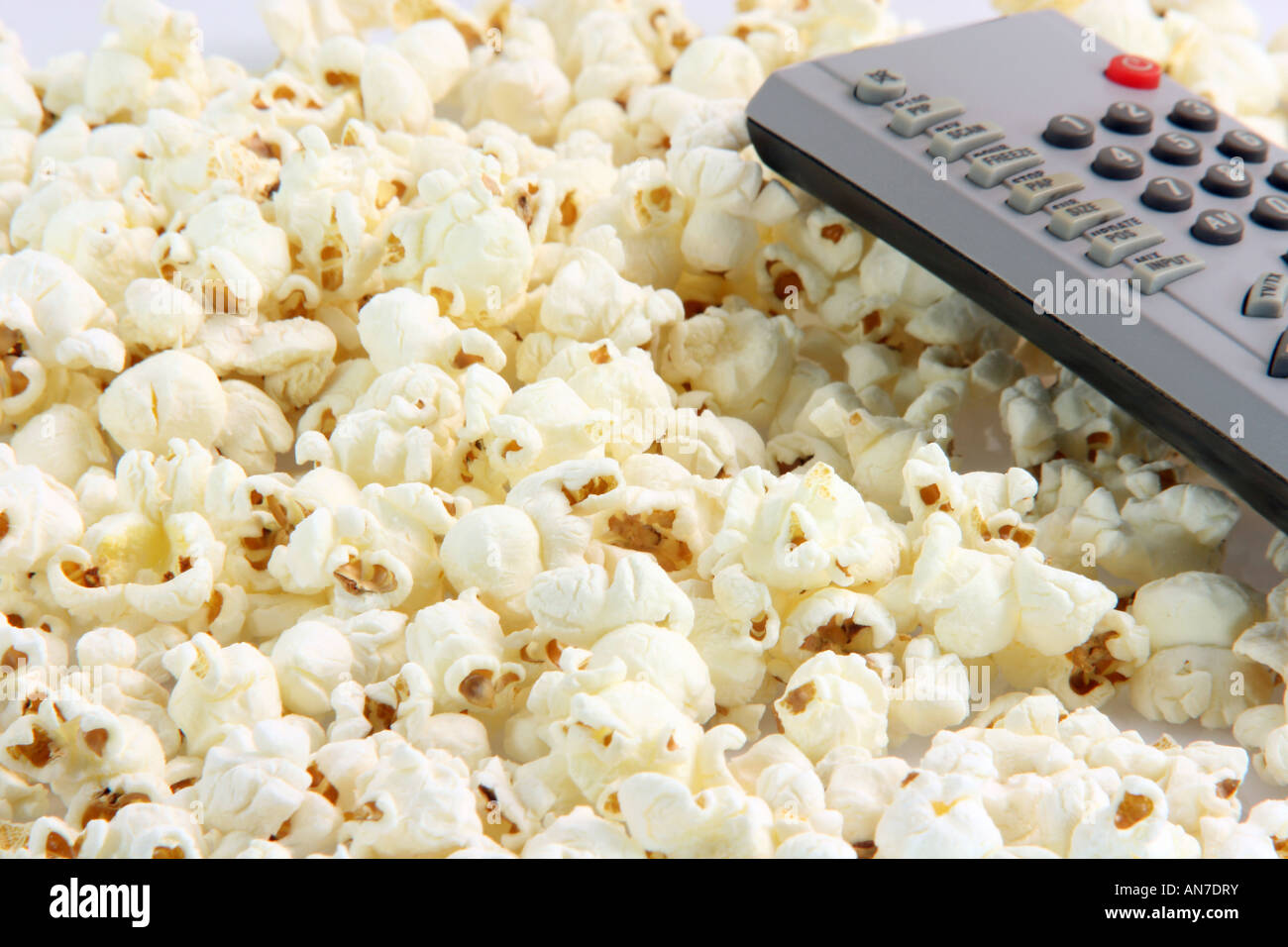 television remote control detail on pop corn background food and ...