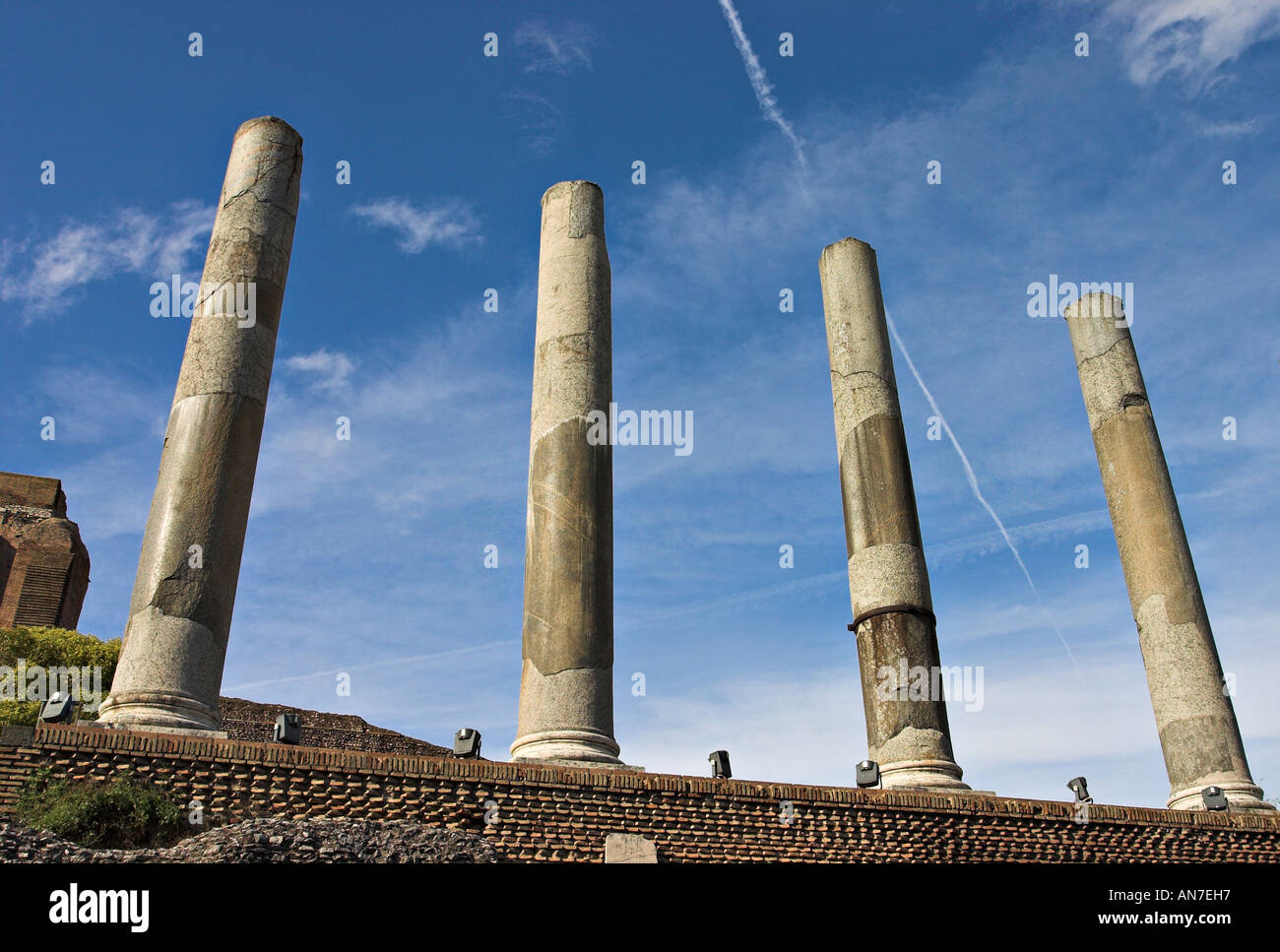 Four Columns Four columns reach skyward in the Roman Forum A blue sky ...