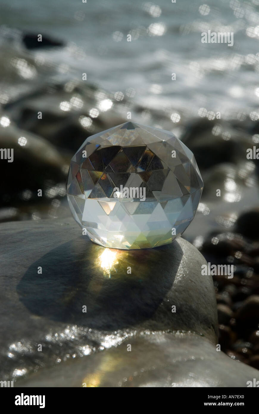 Glass ball crystal ball on pebble beach Stock Photo - Alamy